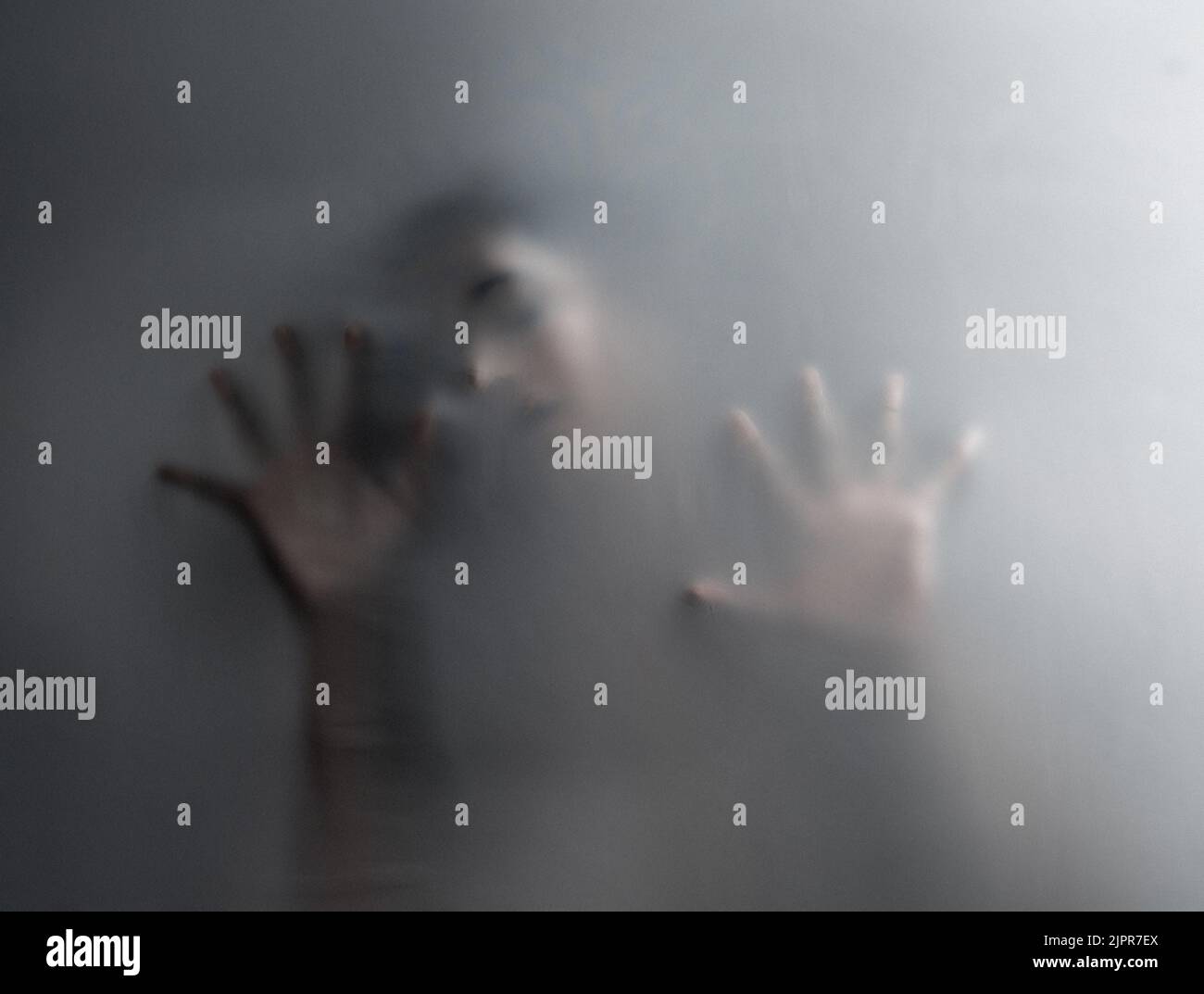 You cannot escape. an unrecognizable woman trapped behind a hazy film ...