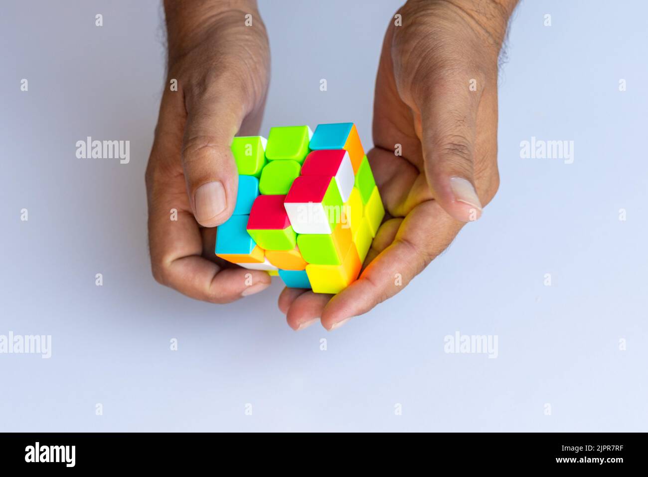 Male hands holding a rubik's cube on a white isolated background Stock ...