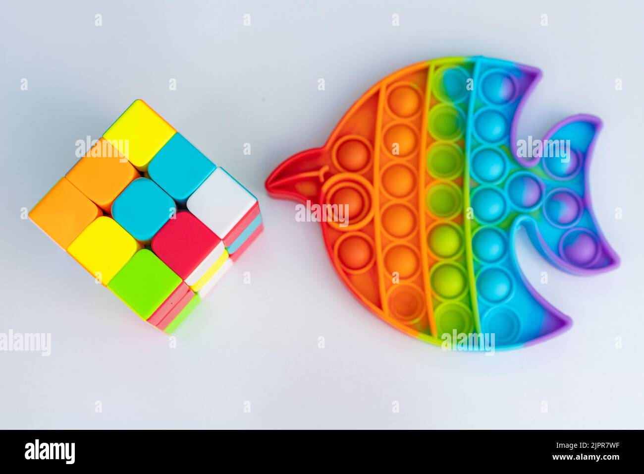 Puzzle cube and pop it silicon toys on a white isolated background ...