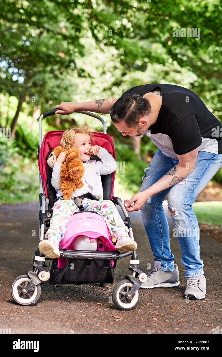 They enjoy many adventure when out on their stroll. a father pushing ...
