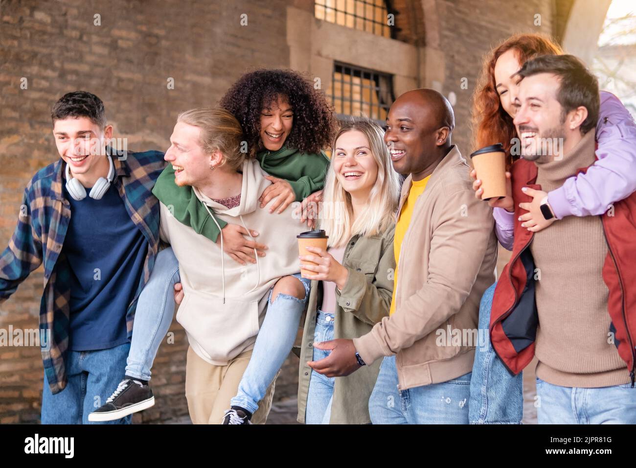 Multiracial young people walking happily on the street - Guys and girls ...