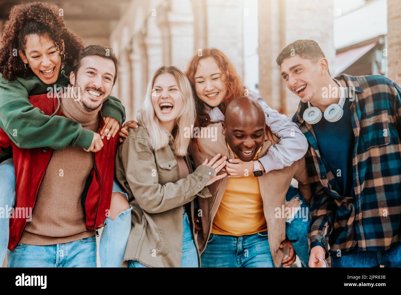 Multiracial young people walking happily on the street - Guys and girls ...