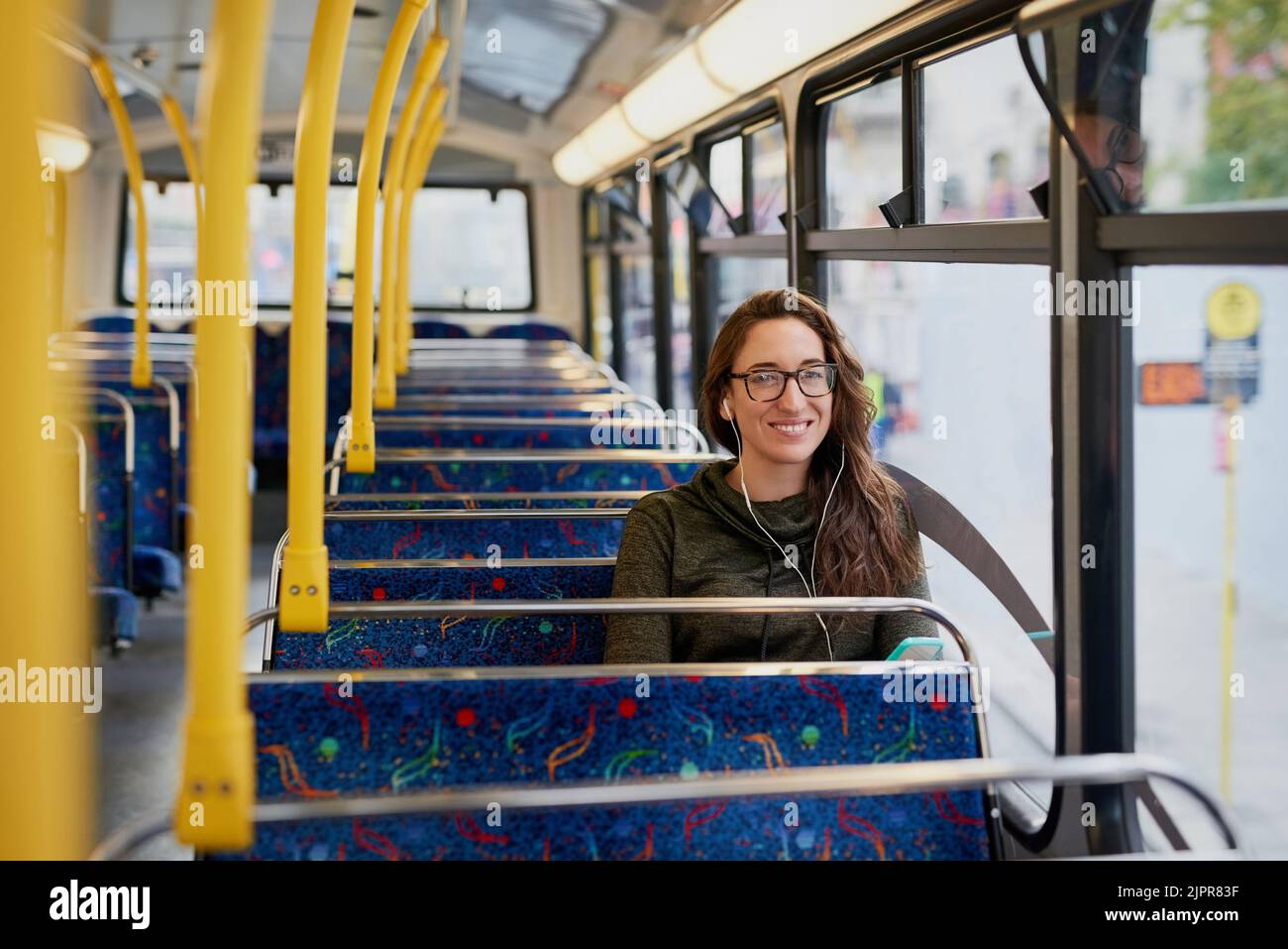This bus takes me everywhere. High angle portrait of an attractive ...