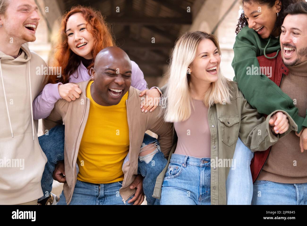 Multiracial young people walking happily on the street - Guys and girls ...