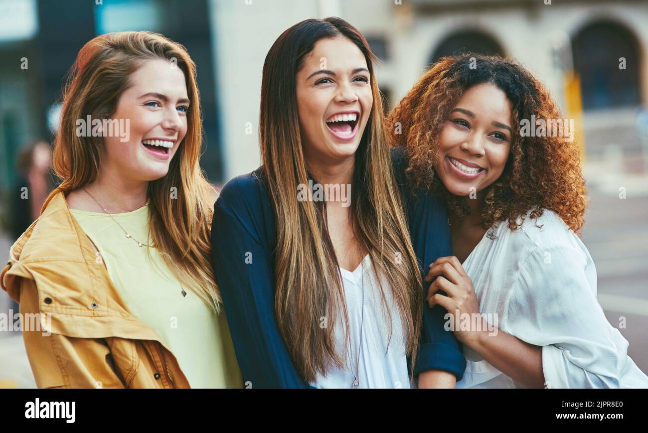 The girls out for some fun. three friends having fun in the city Stock ...