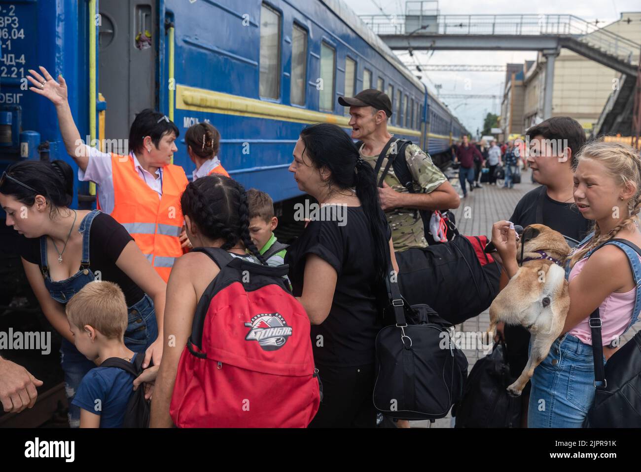 A group of people get into a train car running away from the war ...