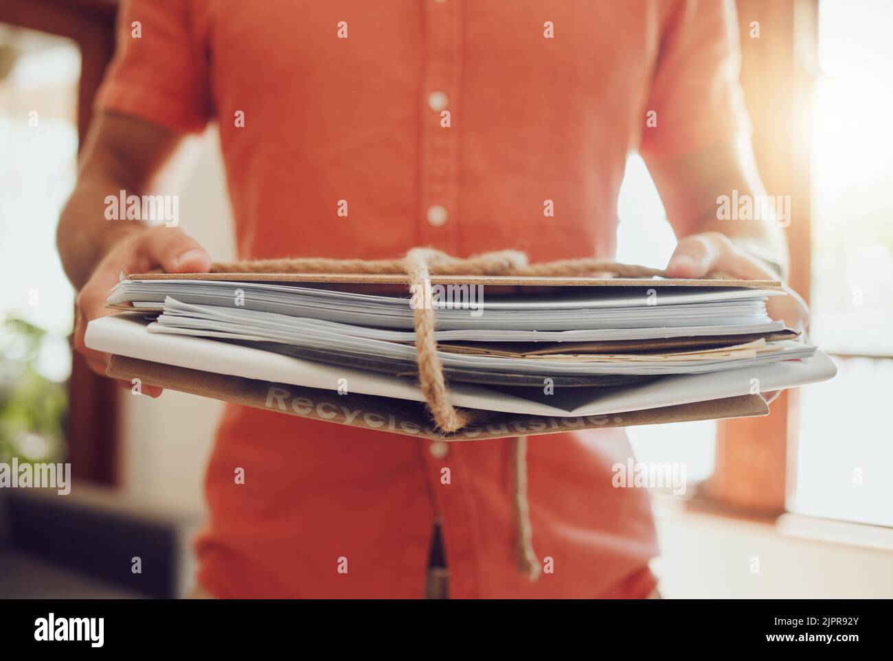 Holding recycle and paper stack closeup of hands inside environmentally ...