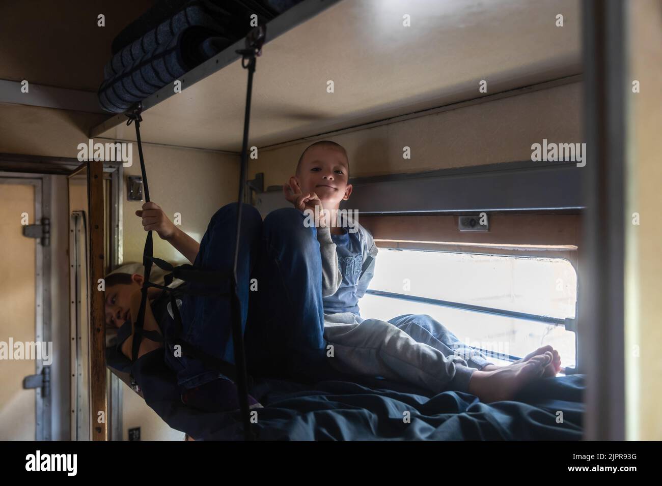 Refugee teenagers in their bed in a train car. Evacuation train from ...