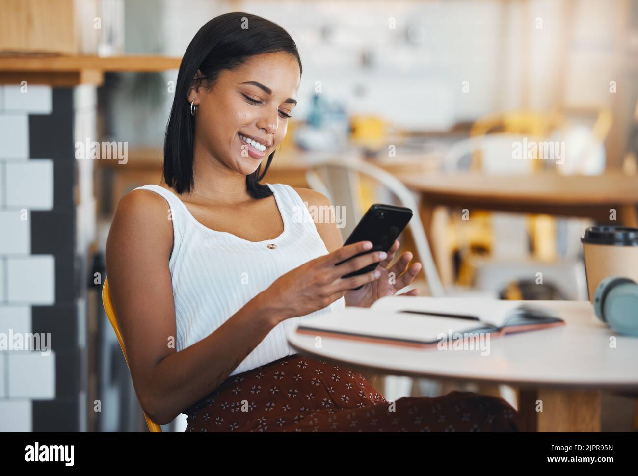 Texting a message or browsing social media on a phone by a young female ...