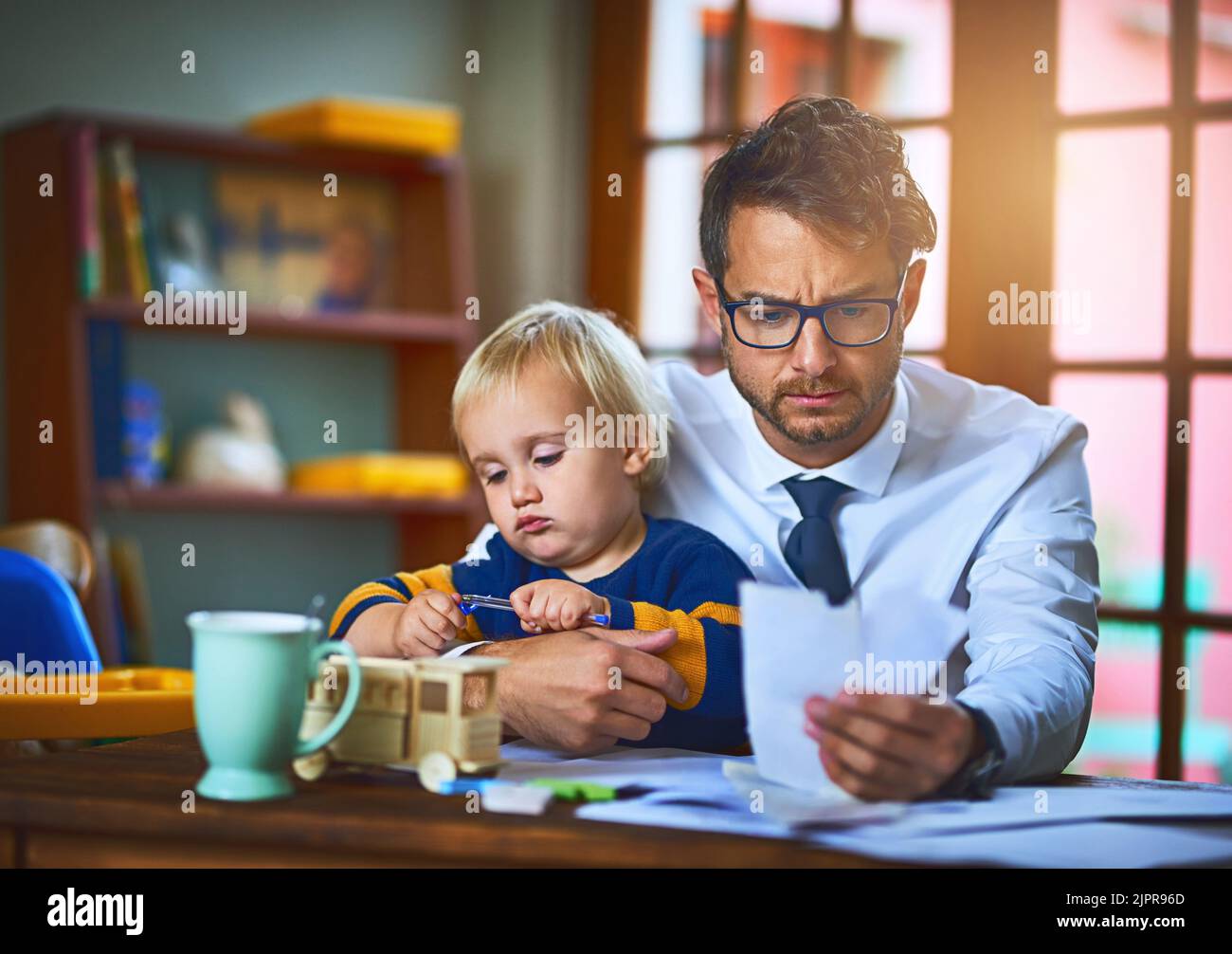 How he spends his weekends. a single father going through paperwork at ...
