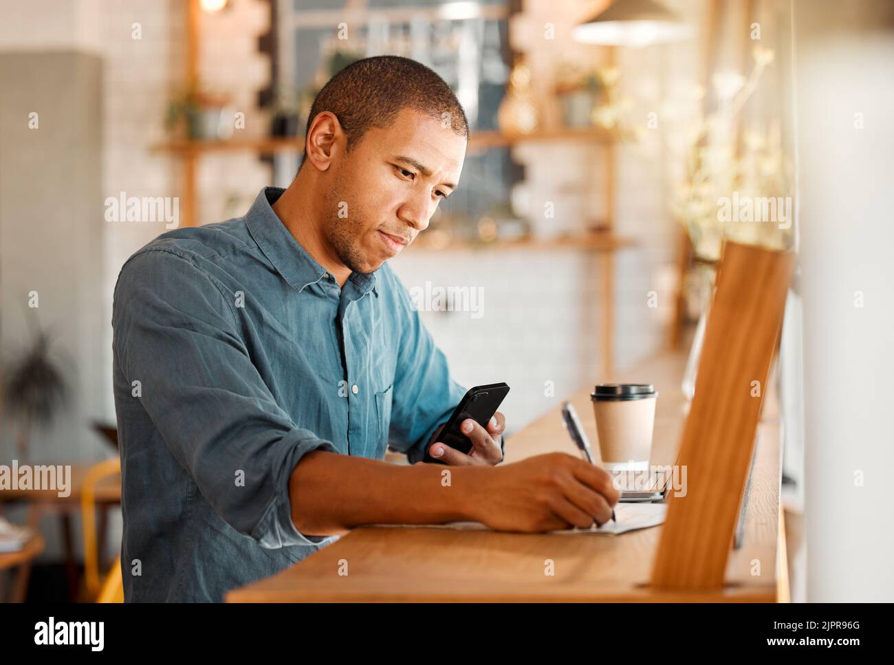 Serious, casual man entrepreneur working in restaurant cafe ...