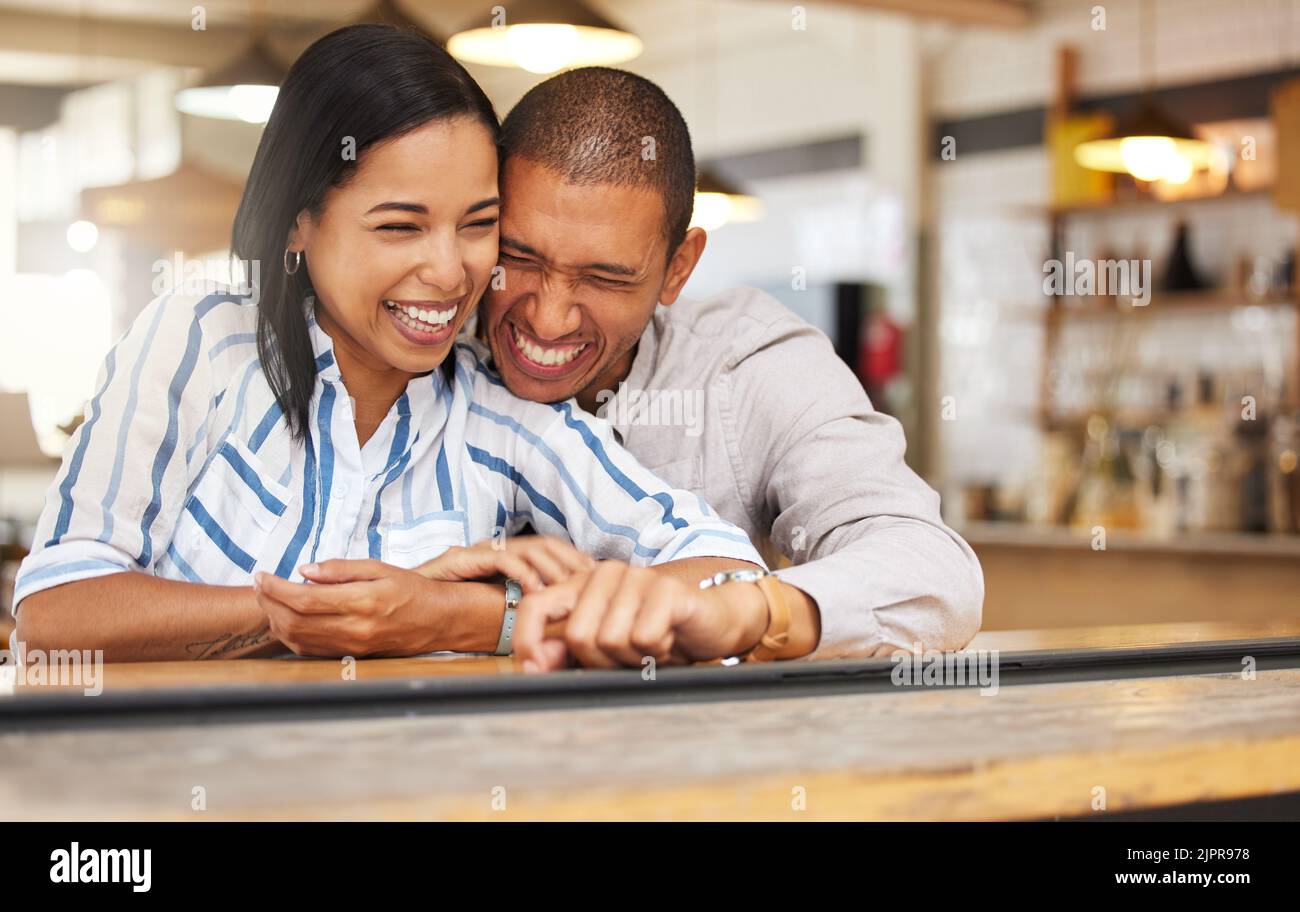Couple laughing at funny joke at restaurant, boyfriend and girlfriend ...