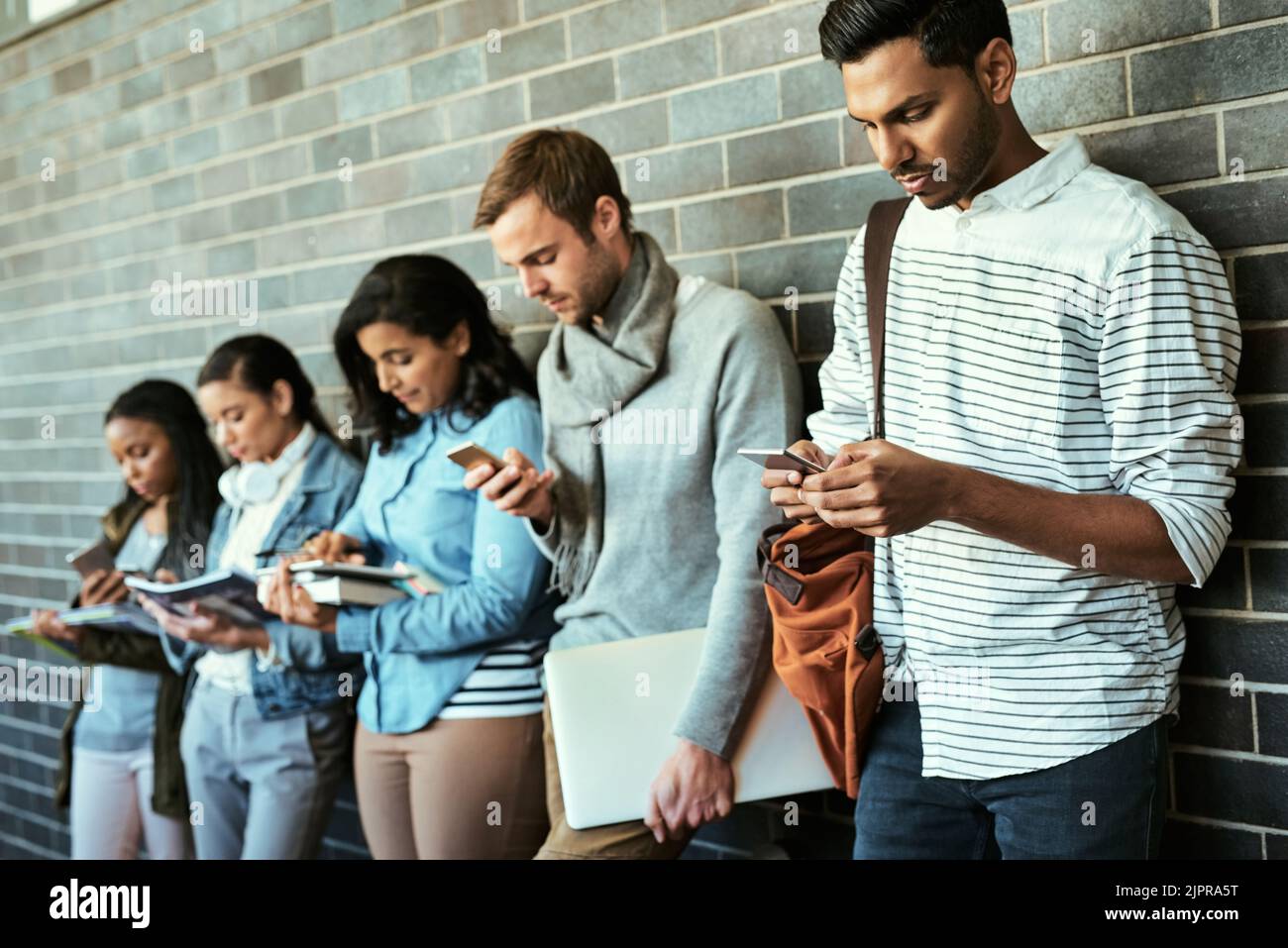 Connected on campus. a group of university students using their ...