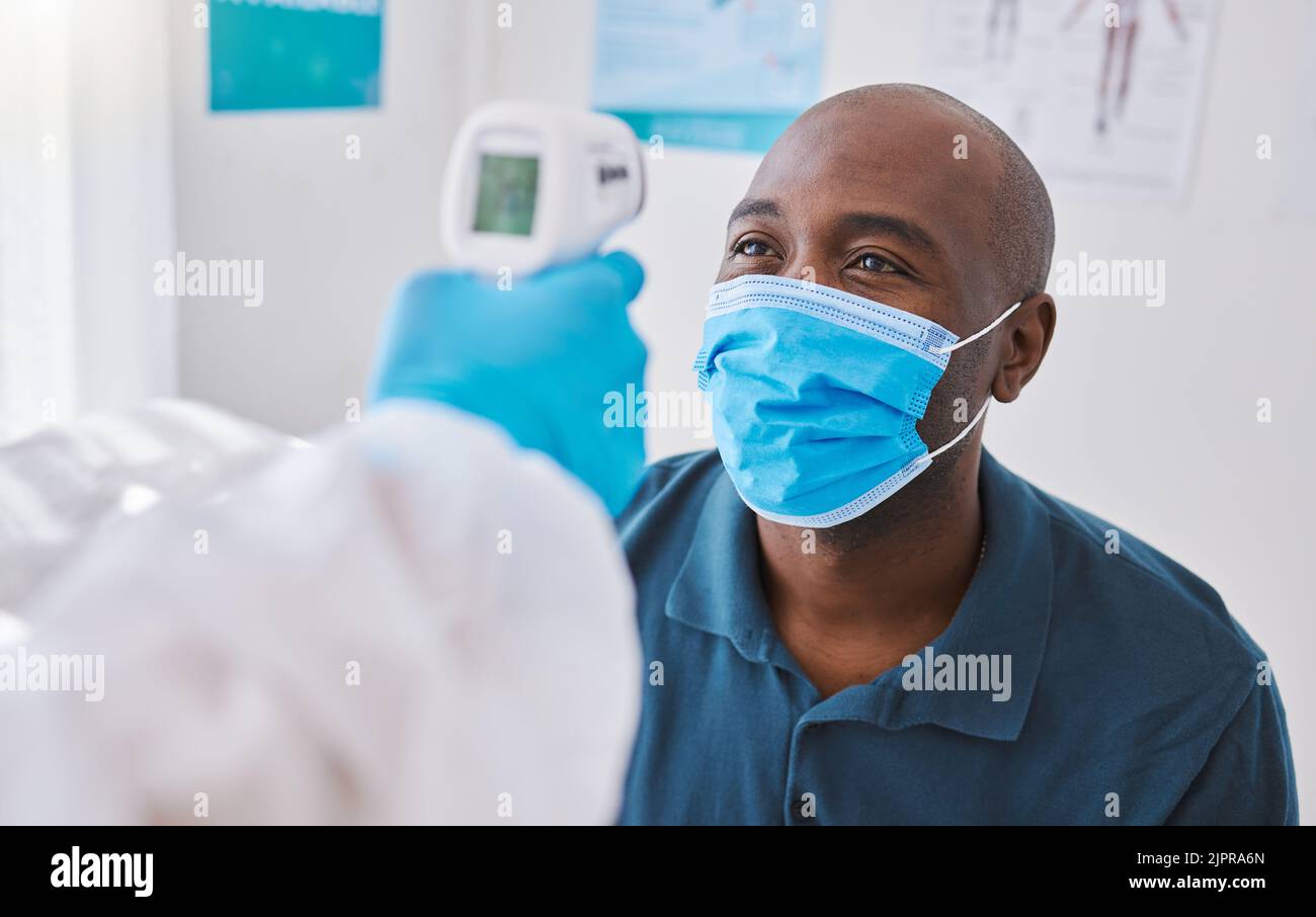 Doctor checking temperature hi-res stock photography and images - Alamy