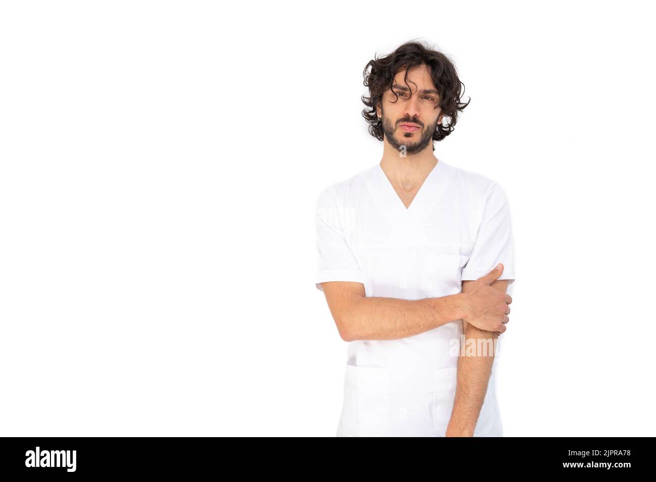 Portrait of a young male nurse in a white uniform isolated on white ...