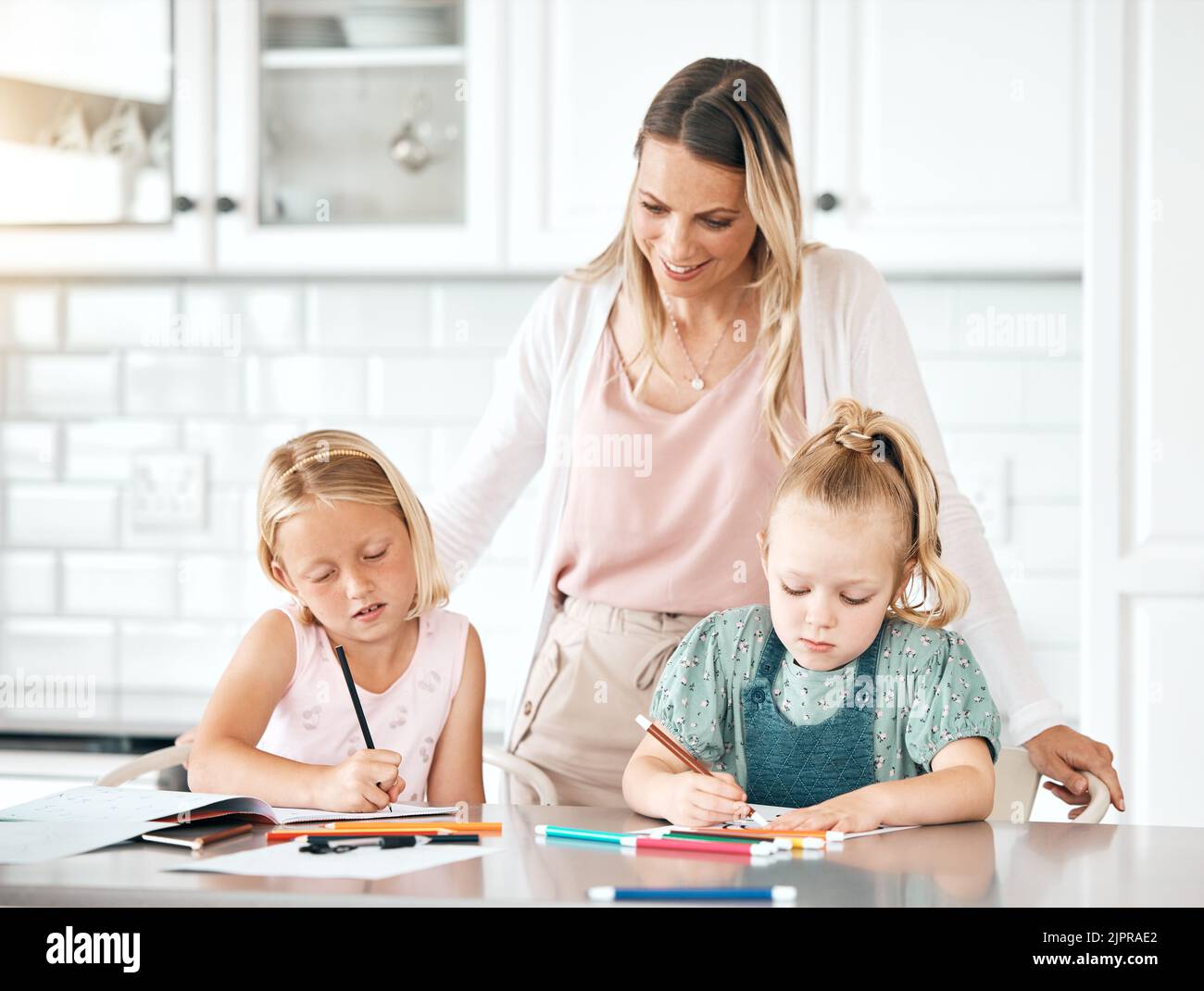 Education, learning and homework with a girl, her sister and their mom ...
