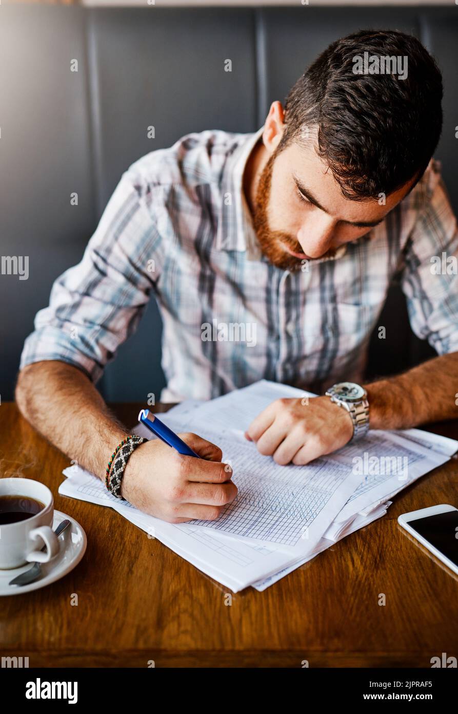 Keeping track of whats happening in his business. a shop owner doing ...