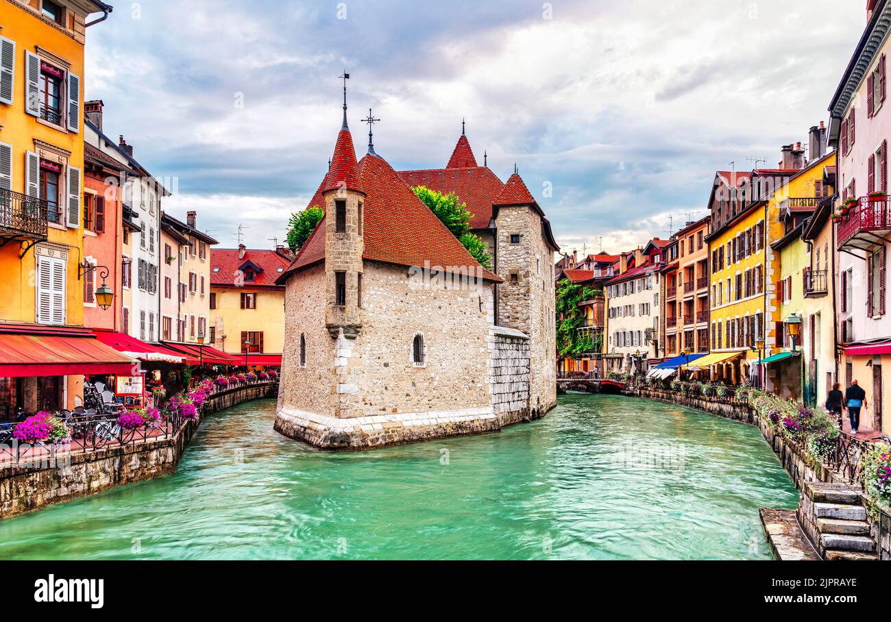 People walk near the Thiou canal in Old Town of Annecy in France ...