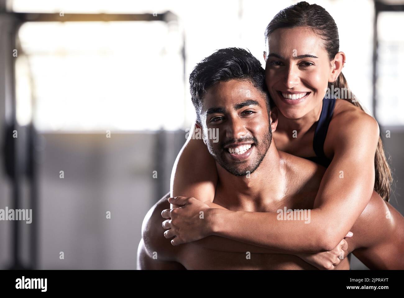 Fitness couple, gym friends and team hugging, holding and celebrating ...