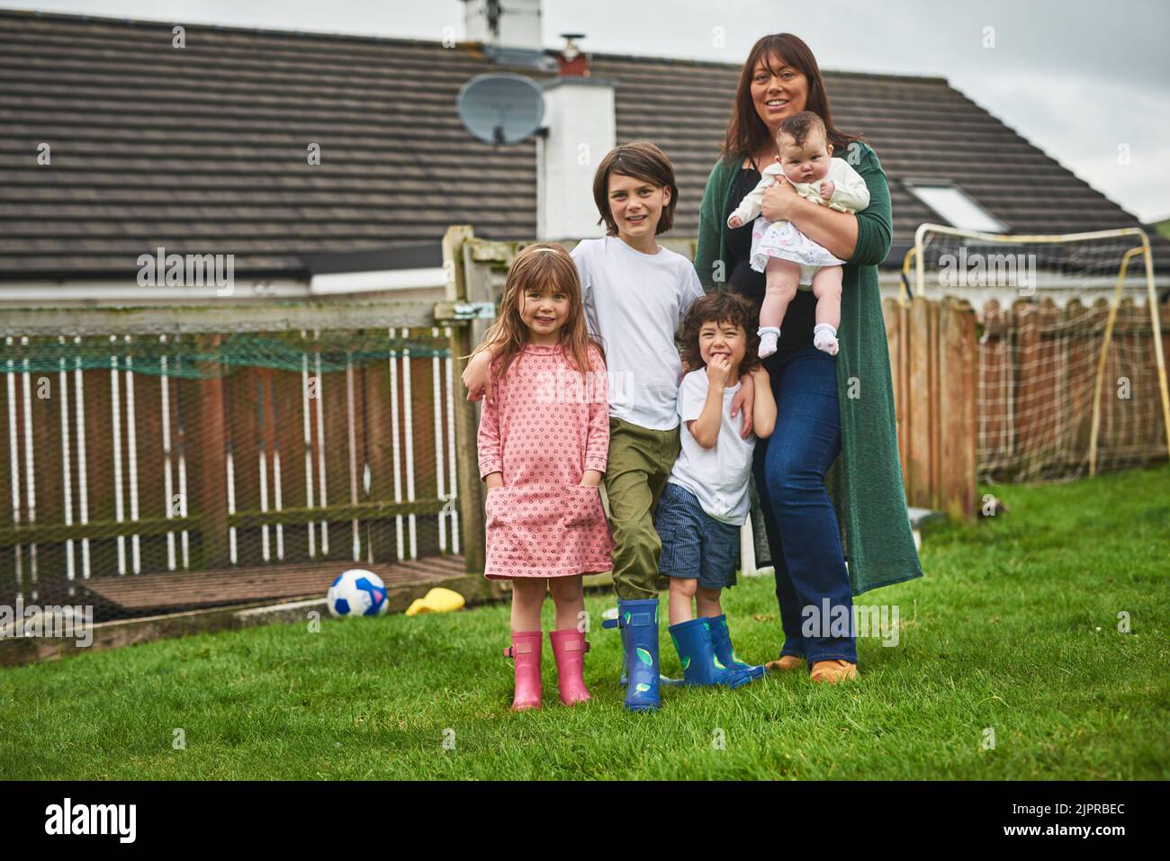 The happiest of families. Portrait of a mother and her four little ...
