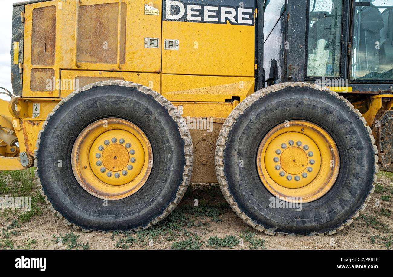 Large tires on the side of a John Deere 772GP Grader parked at a farm ...