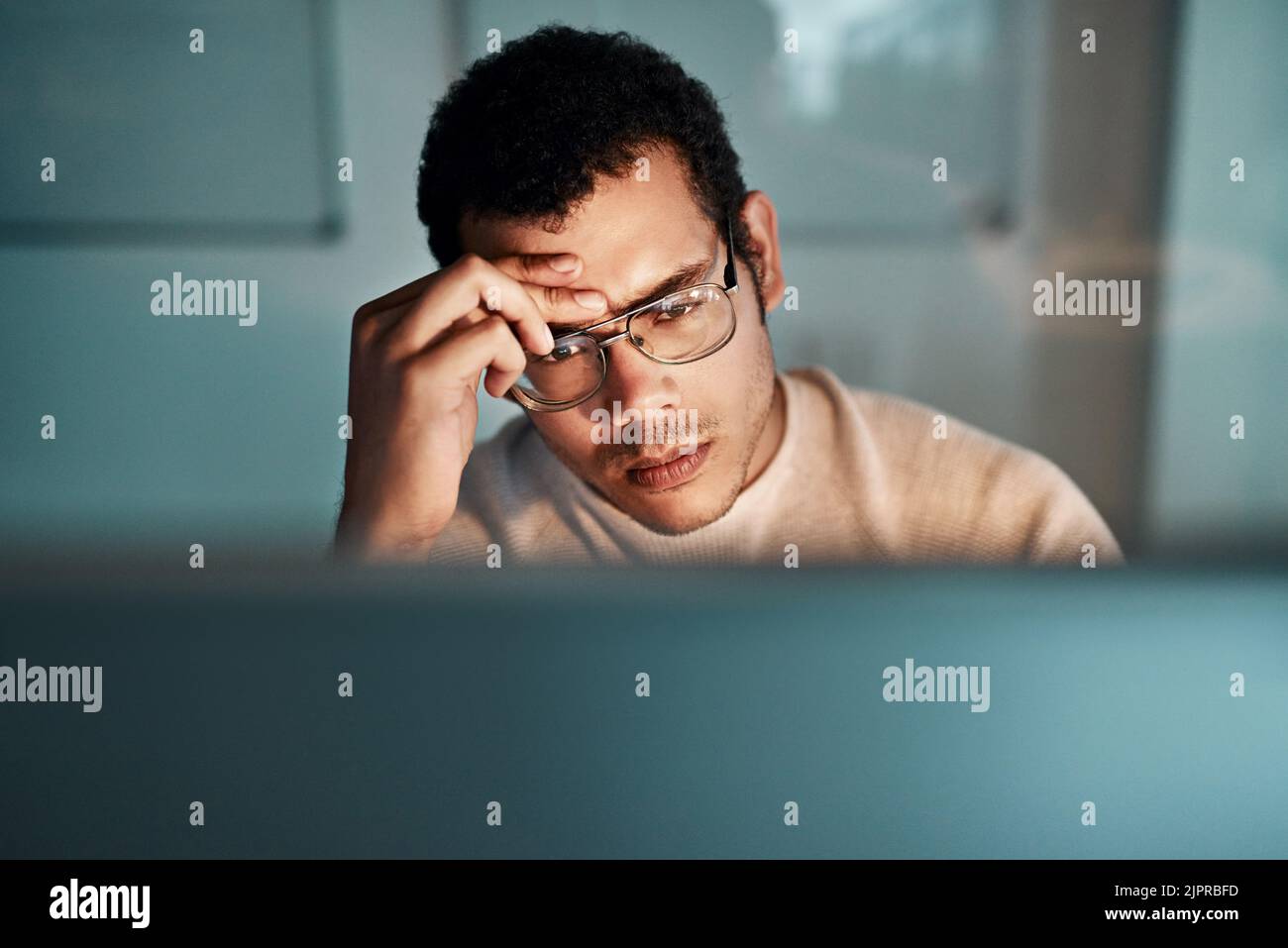 Productive at any hour. a young businessman working late at the office ...