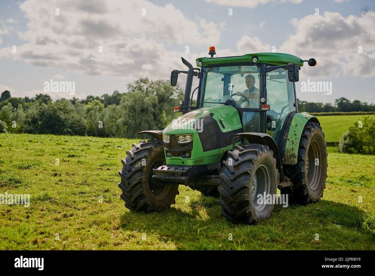 Every farm needs a tractor. Full length shot of a green tractor on an ...