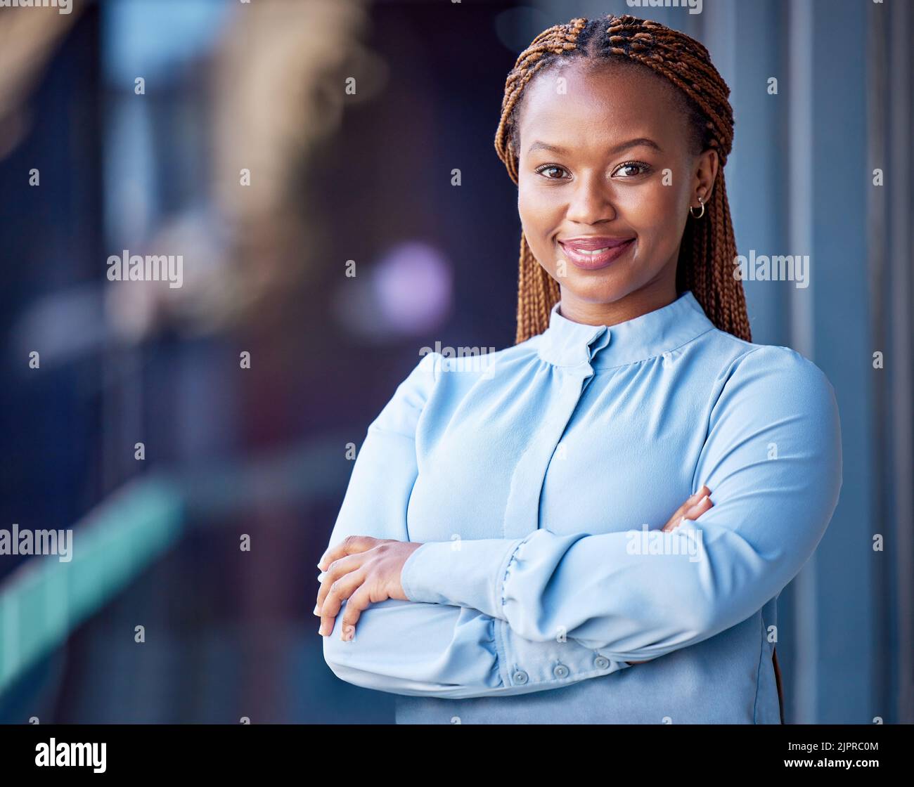 Confident, proud and satisfied business woman standing with arms ...