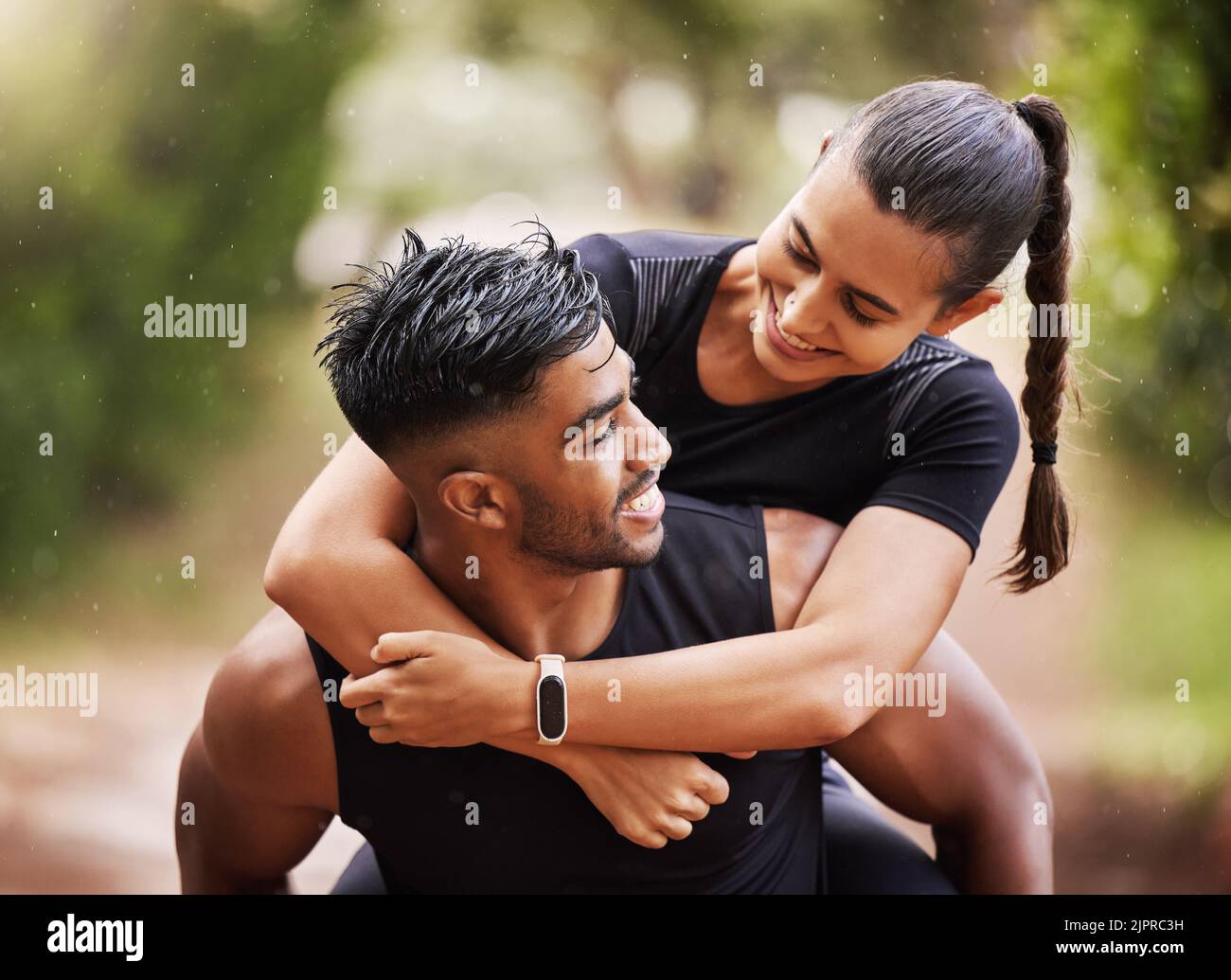Fun and playful couple playing on a hike in nature, giving piggyback ...