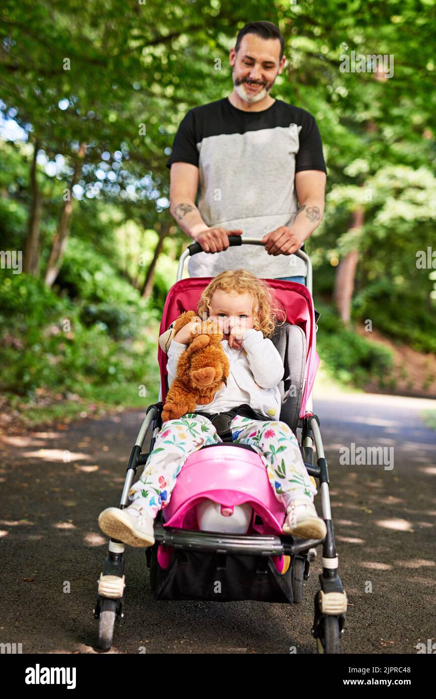 Daddy and daughter time. Portrait of a father pushing his little ...