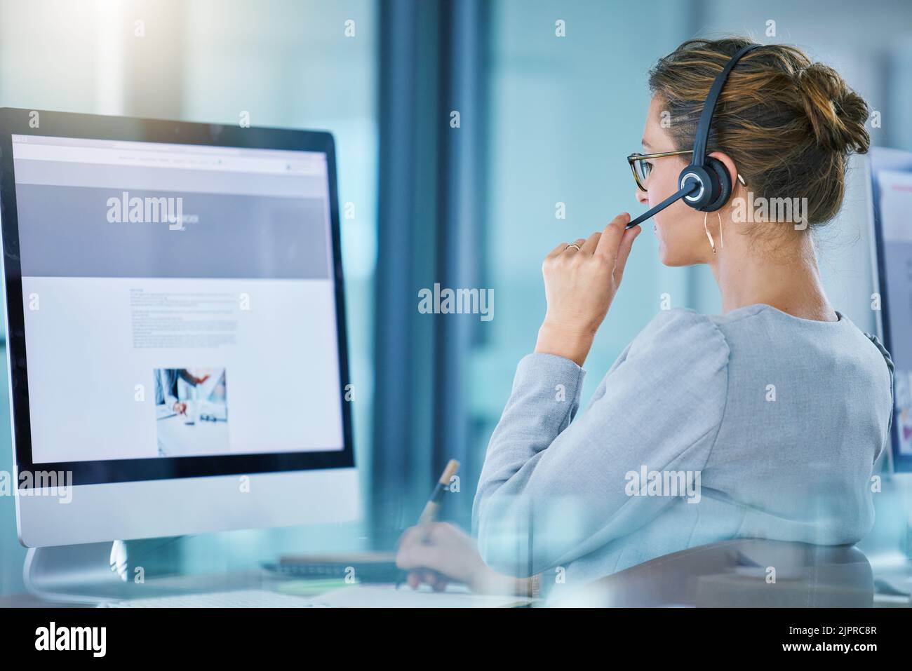 CRM call center agent talking using wireless headset, consulting client ...