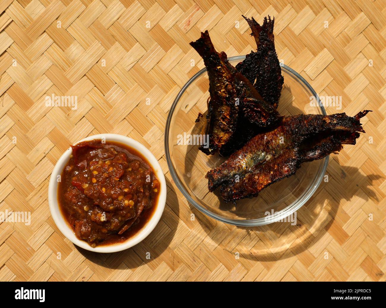 Delicious fried salted fish served with chili sauce Stock Photo - Alamy