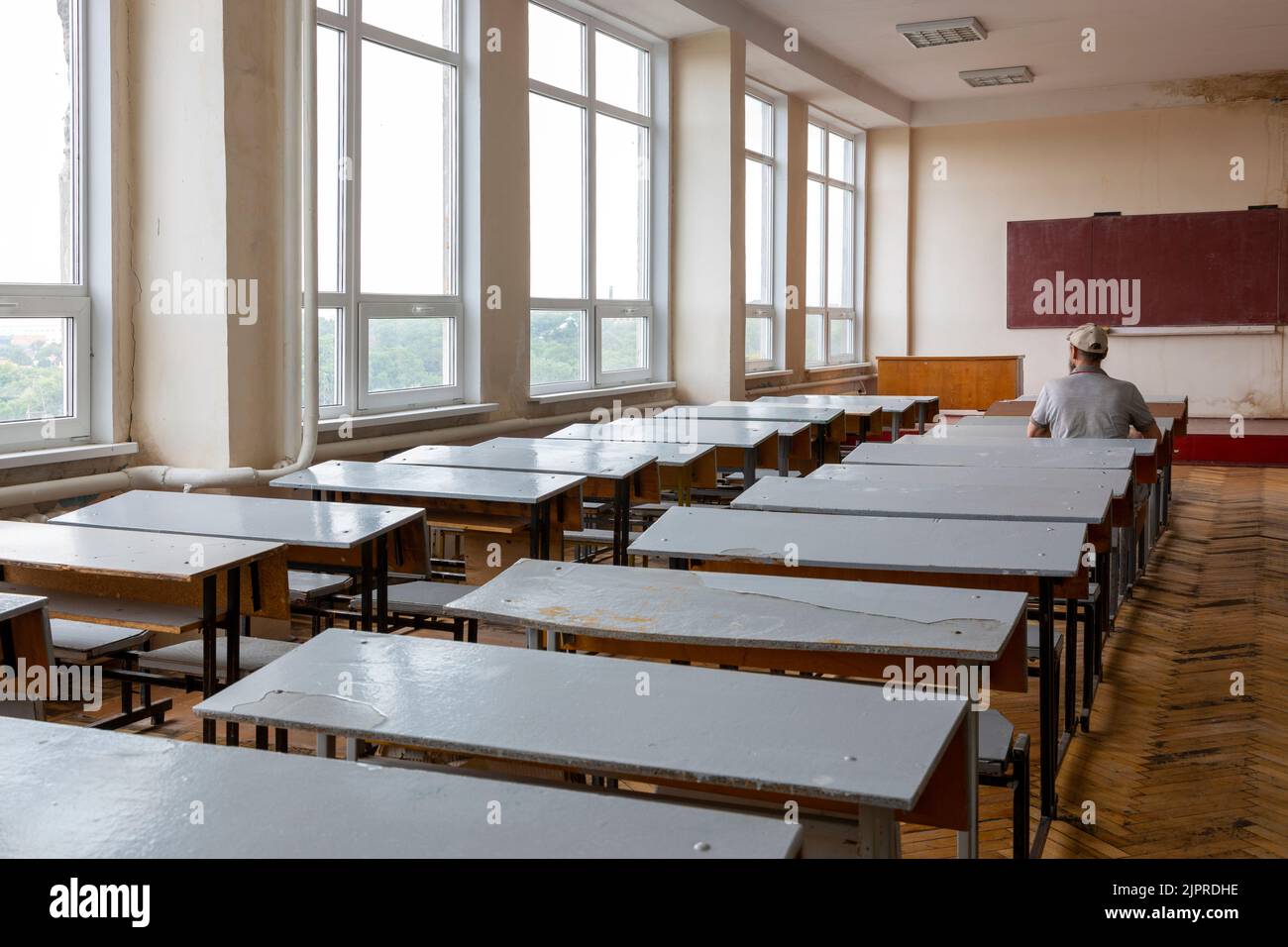 Detail Interior classroom with blackboard on the wall and a person at ...