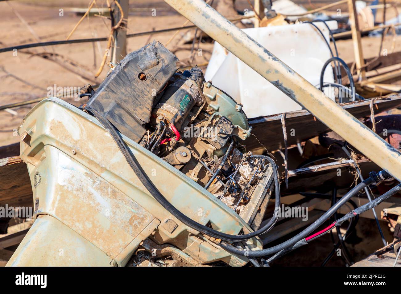 Photograph of a severely flood damaged boat outboard engine covered in ...