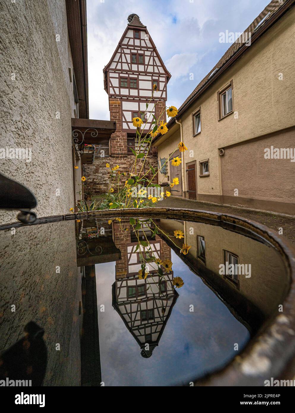 View of the stork tower with reflection in water of a rain barrel, Weil ...