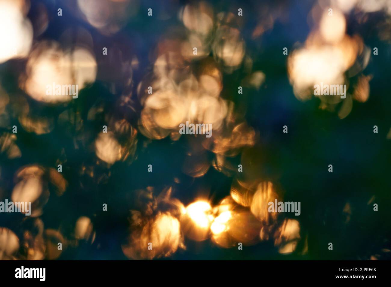 Out of focus. Circular bokeh of black and orange curves in backlight ...