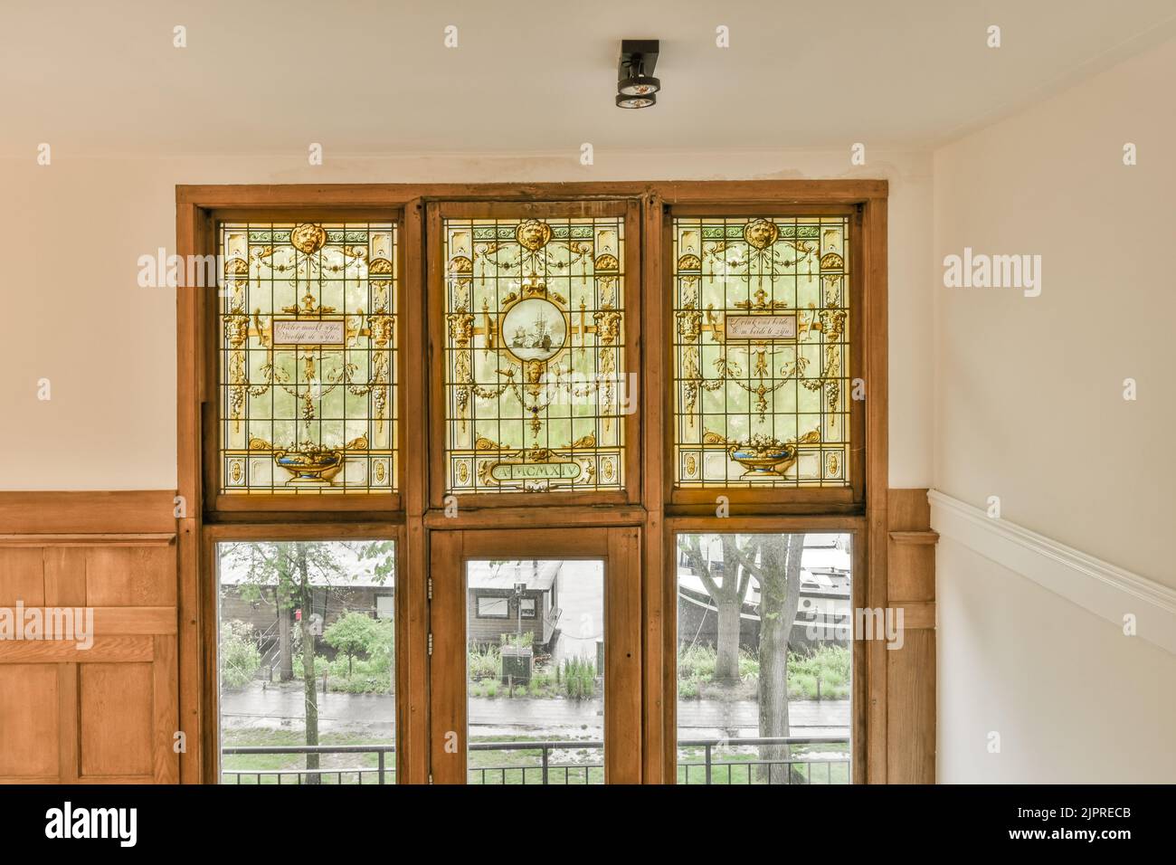 Comfortable sofa with cushions placed against light wall with TV and ...