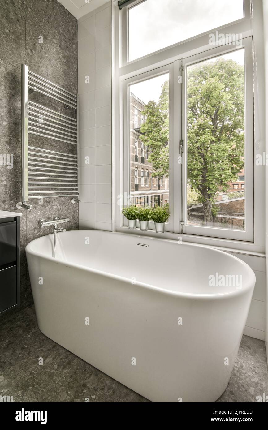 Modern home interior design of white bathroom with open bathtub and ...