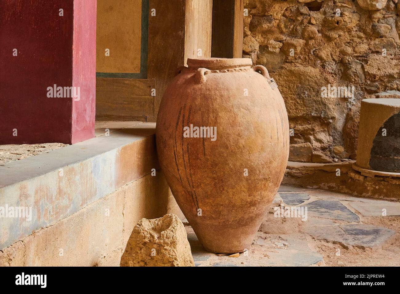Single pithoi, clay vessel, red rectangular column, stone wall, stone ...
