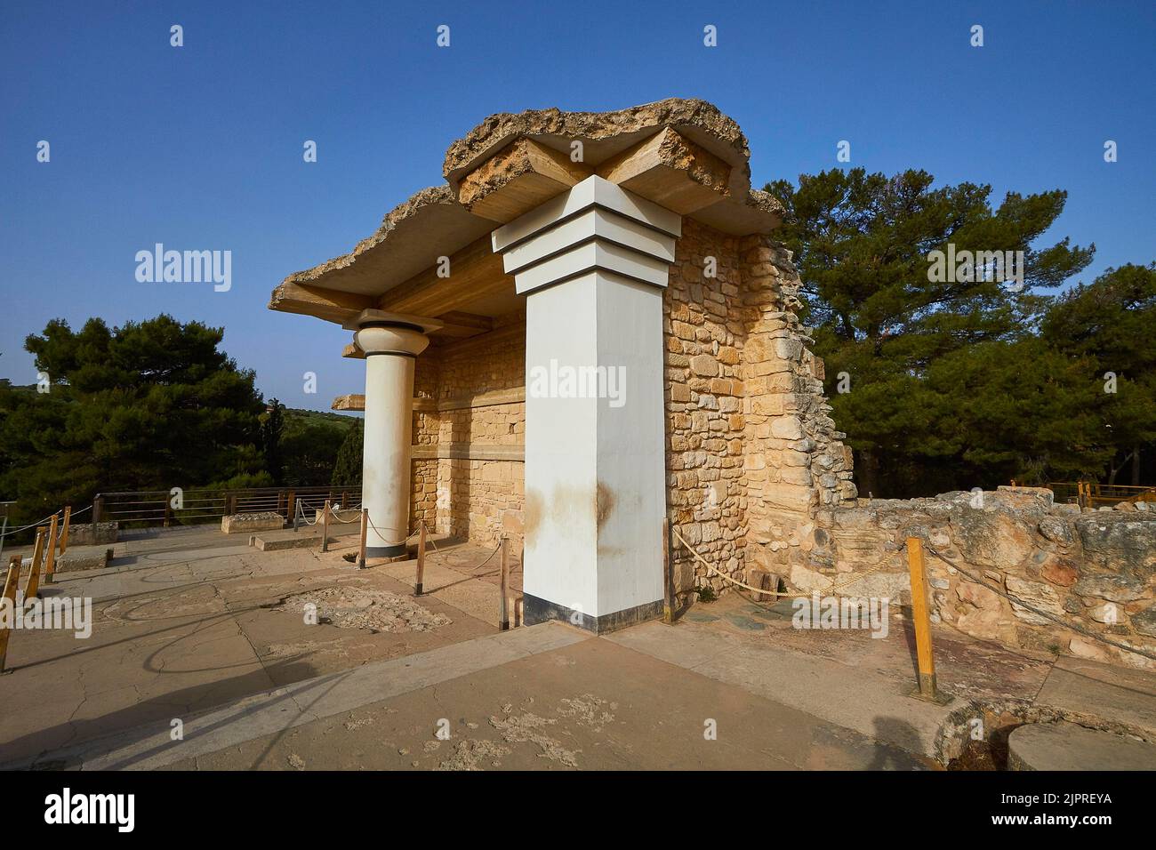 Morning light, blue cloudless sky South Propylaea, round white column ...