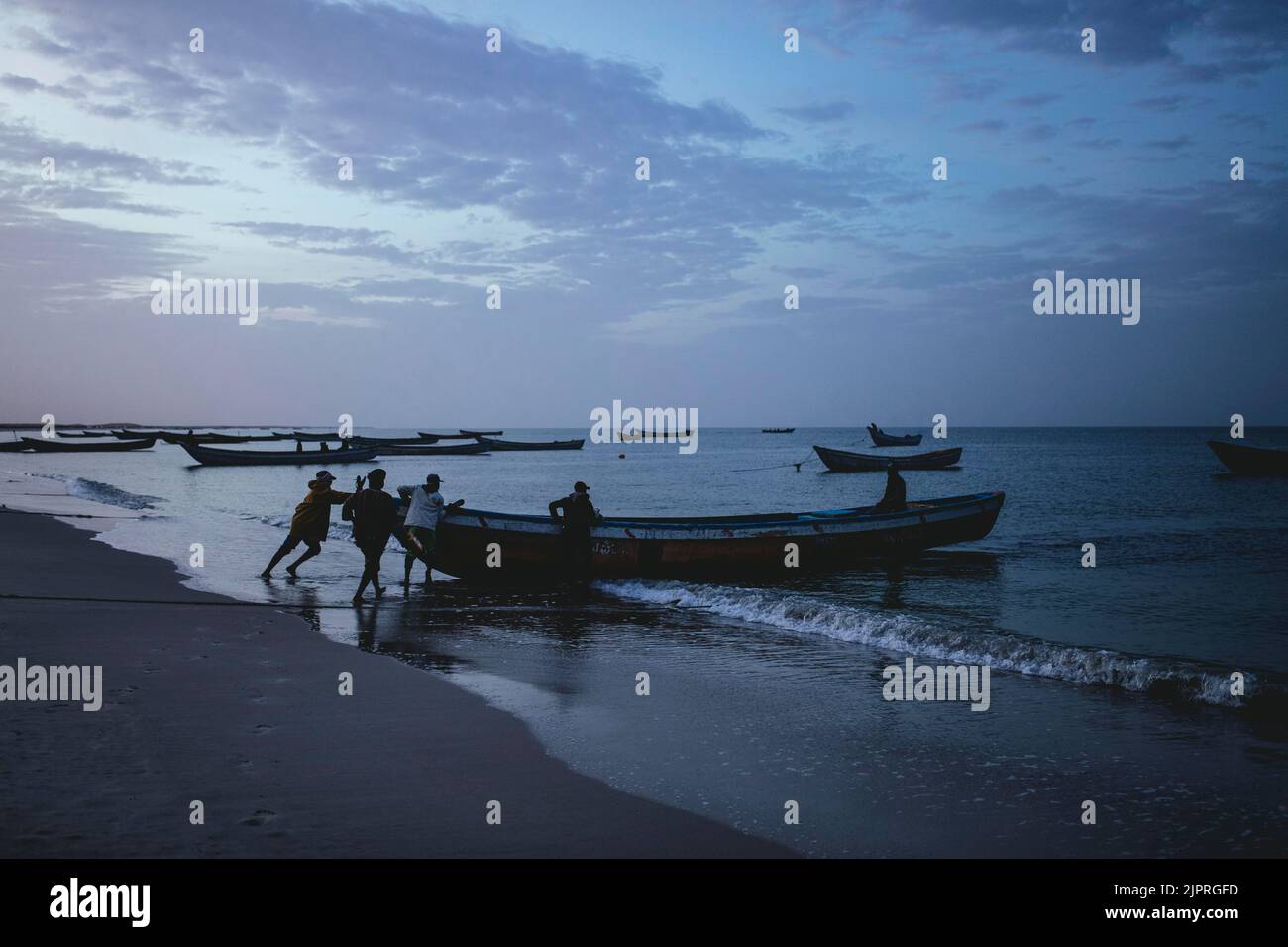 Fishing boats set sail at dawn, fishing village on the Atlantic ...