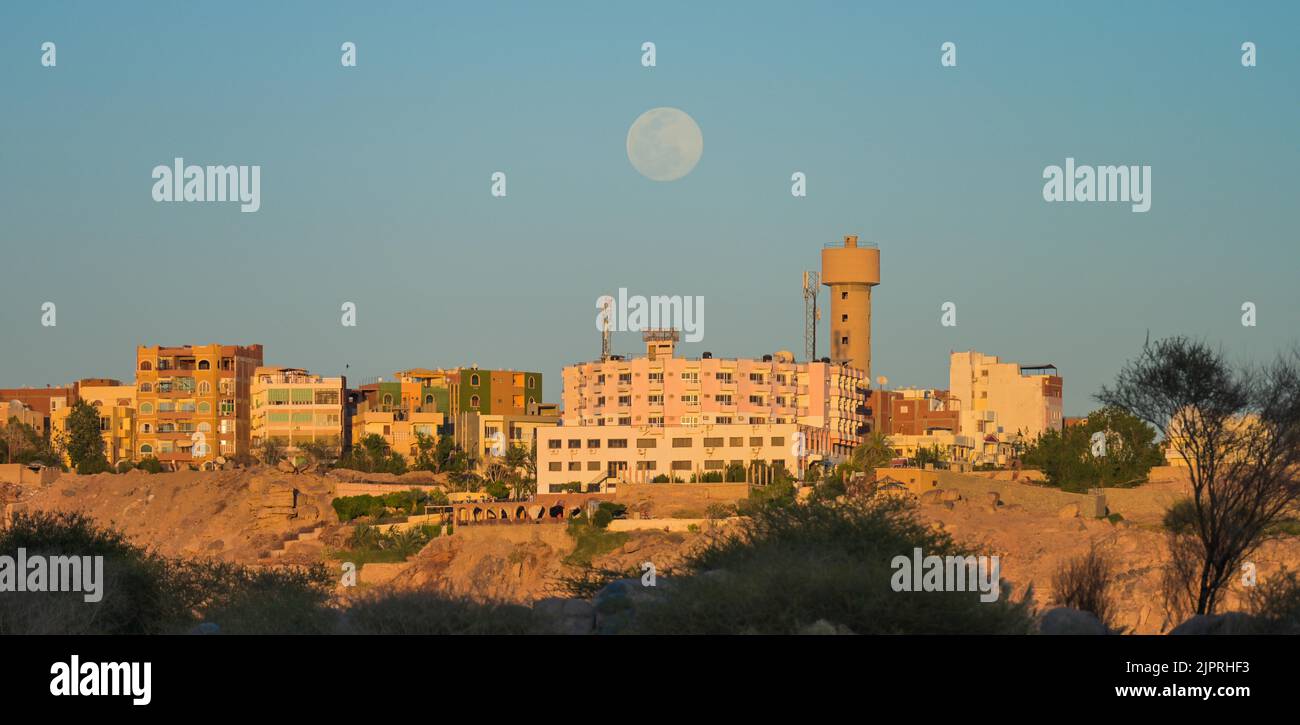 Full moon over housing estate south of Aswan, Egypt Stock Photo - Alamy