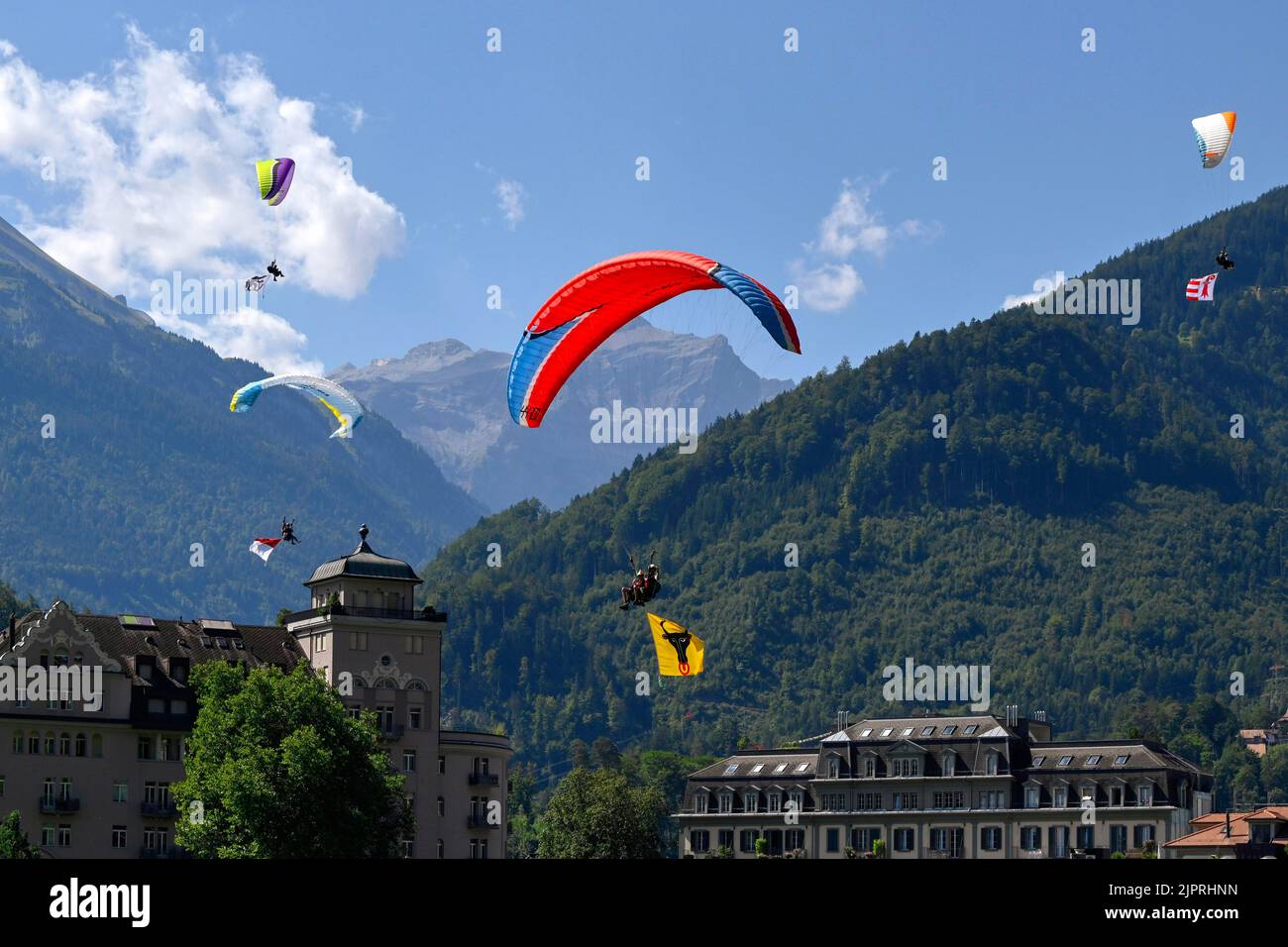 Paraglider Canton flags, Interlaken, Switzerland Stock Photo - Alamy