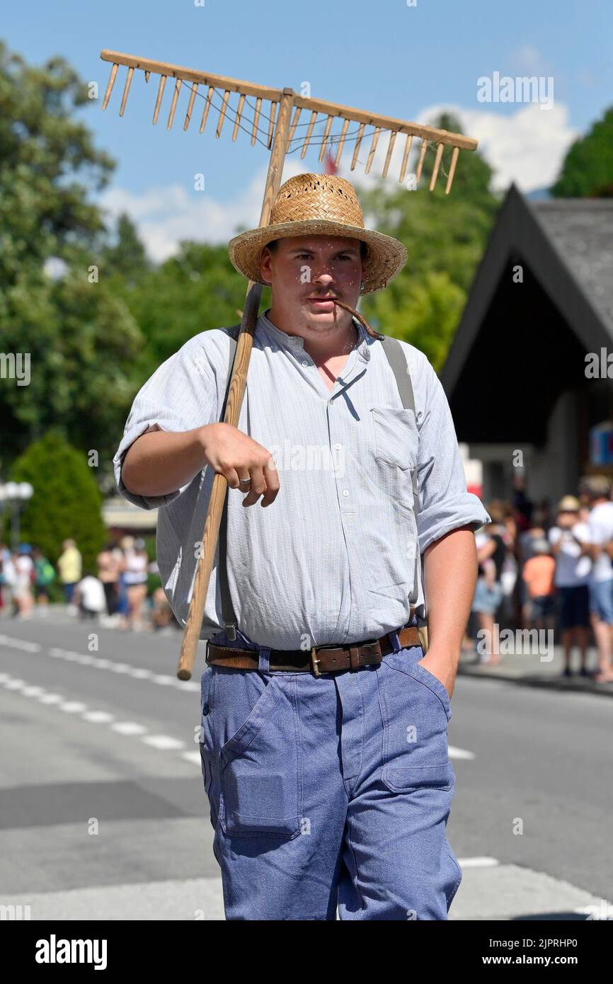 Parade man with hay rake Stock Photo - Alamy
