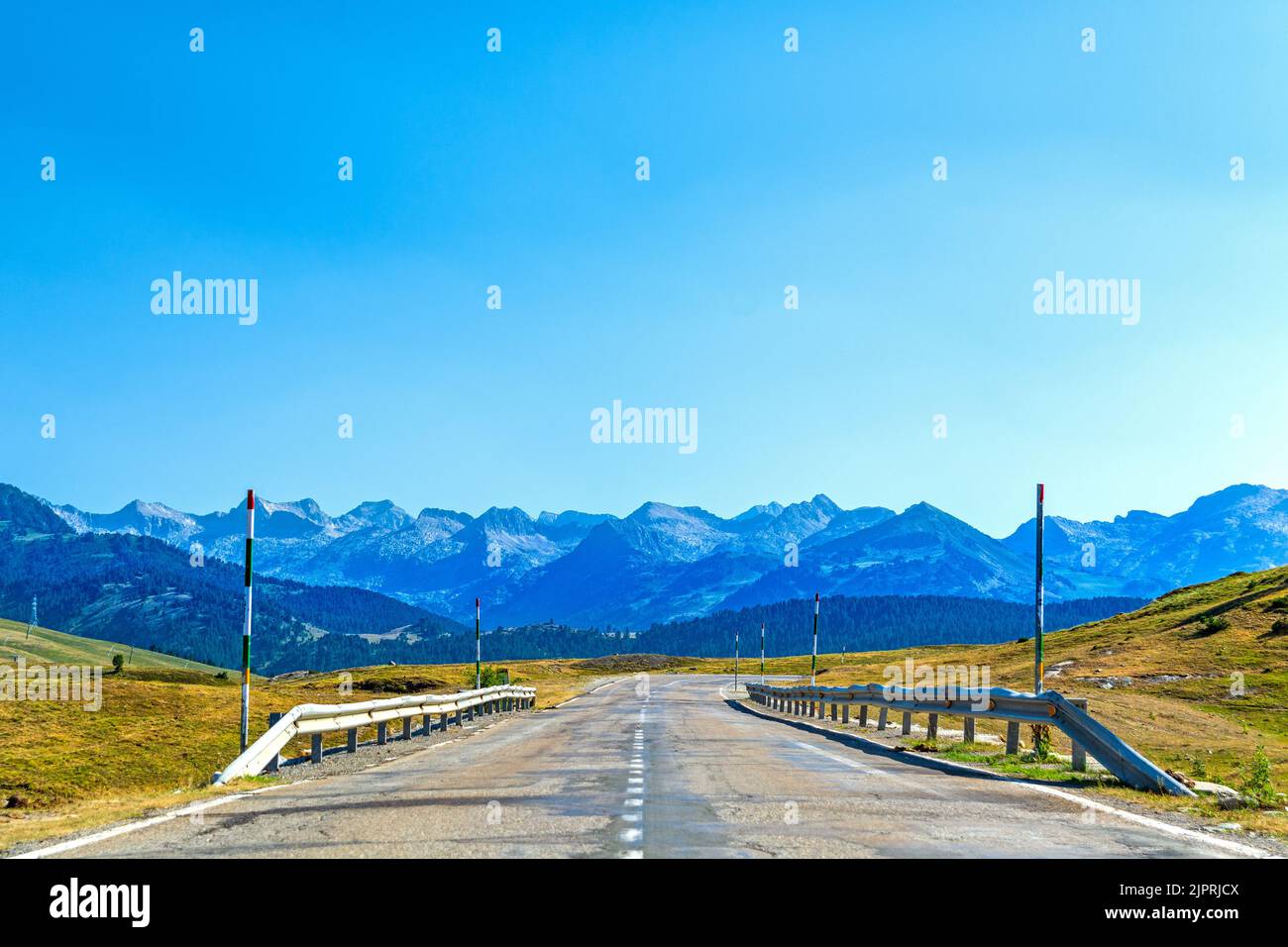 Asphalt road high in the Pyrenees Mountain range on beautiful summer ...