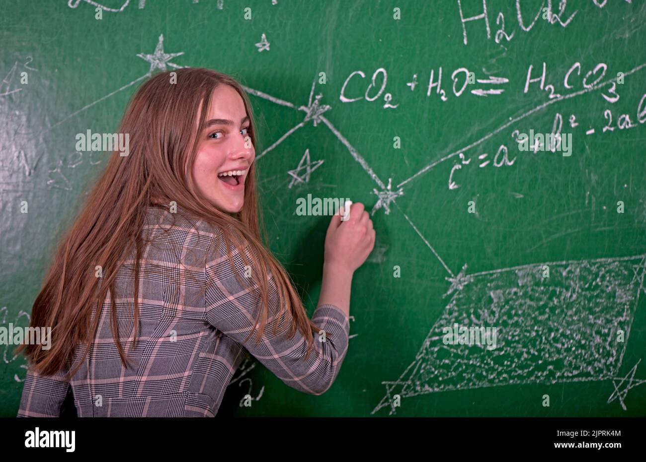 Student girl standing near clean blackboard in the classroom Stock ...