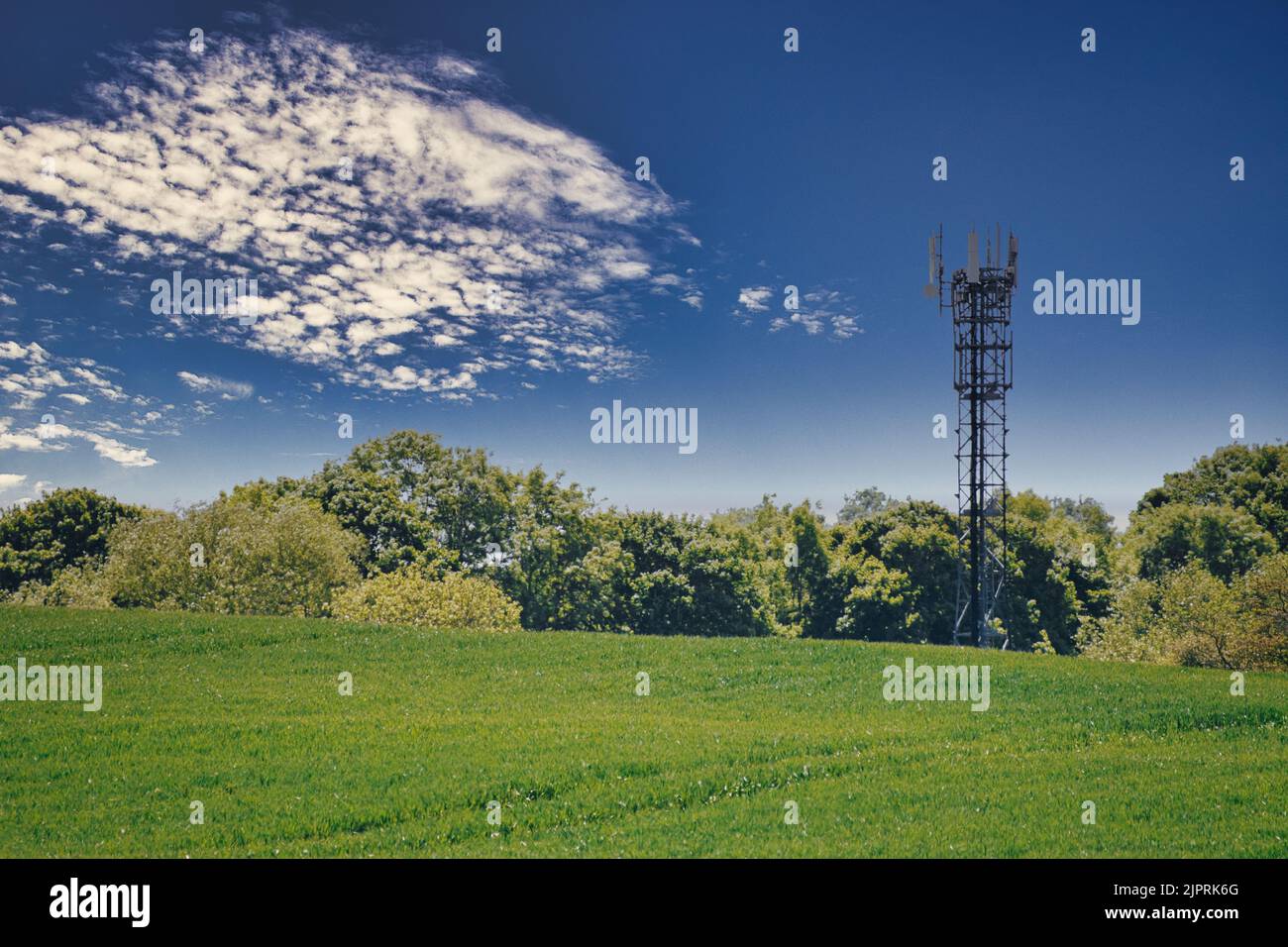 A closeup of a telecommunication tower in a green field Stock Photo - Alamy