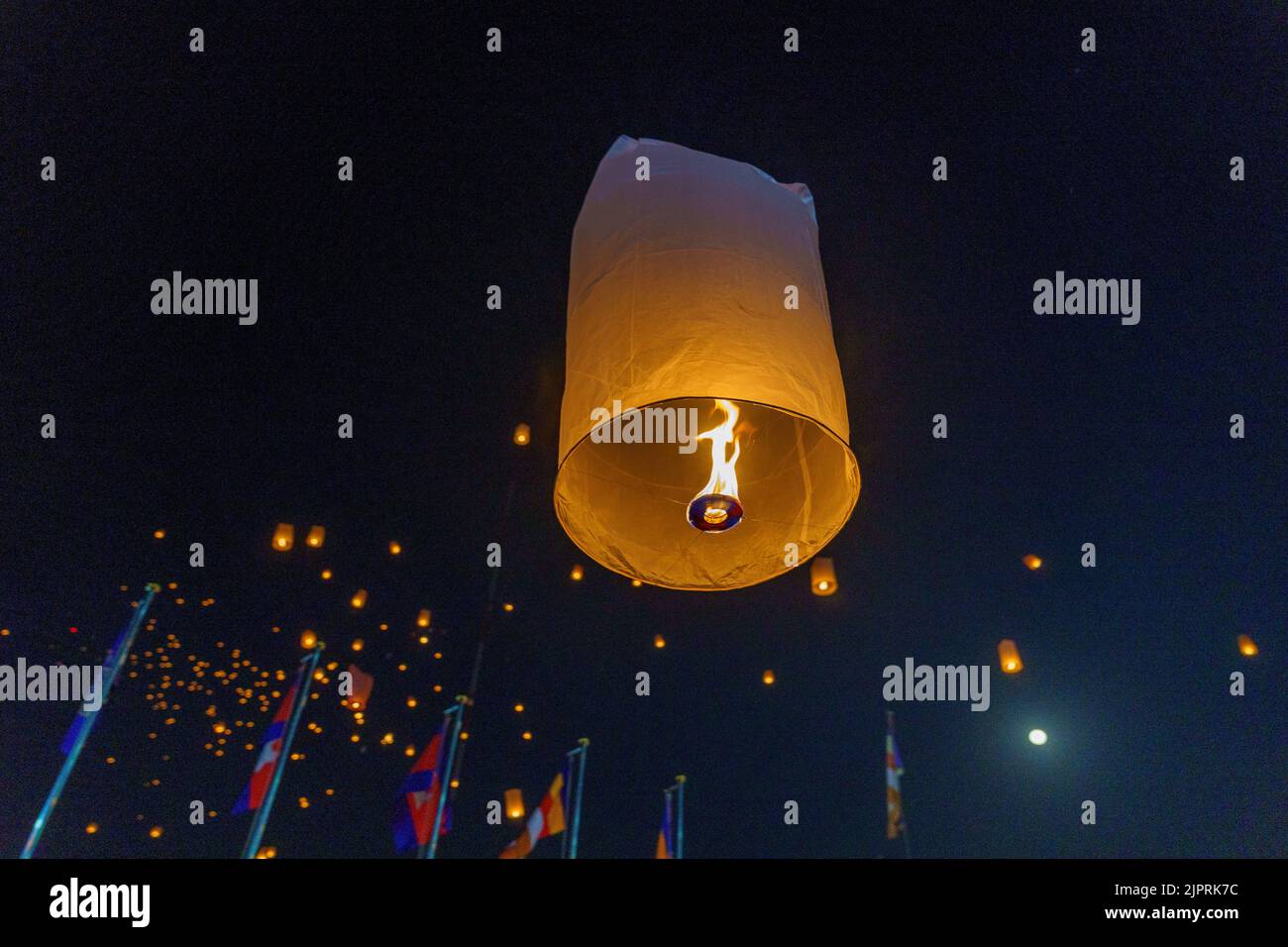 A low angle of a lantern flying in the night sky during Chum Ben ...