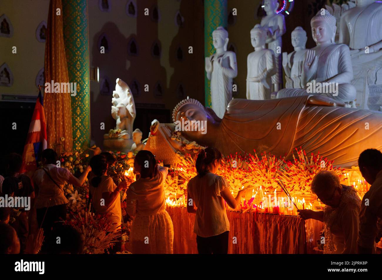 A view of Cambodians offering prayers to Buddha's statue during Pchum ...