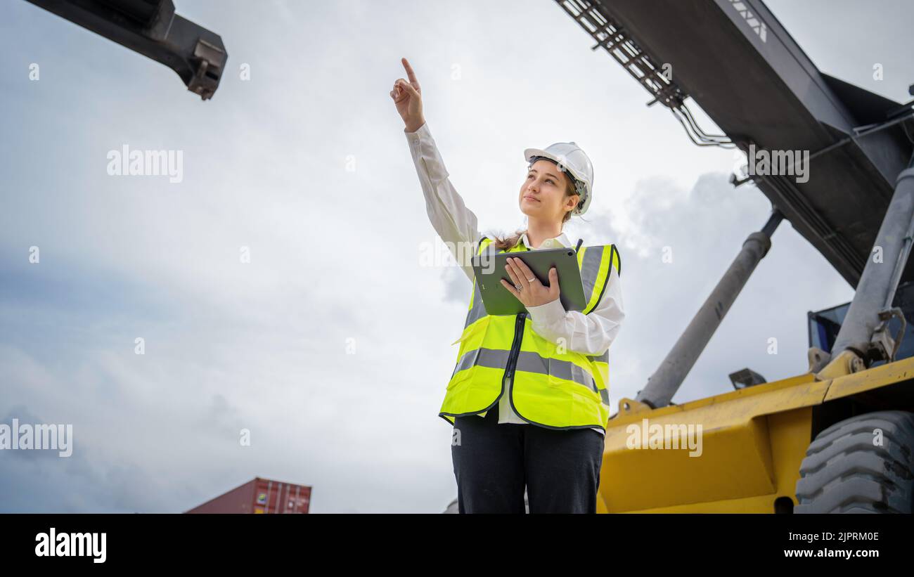 Woman foreman control forklift loading Containers cargo from Truck to ...